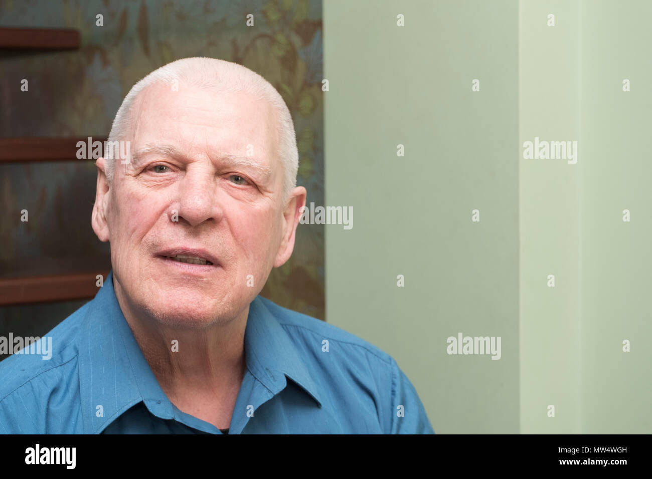 Posrtrait of a positive looking old man, indoor shot Stock Photo - Alamy