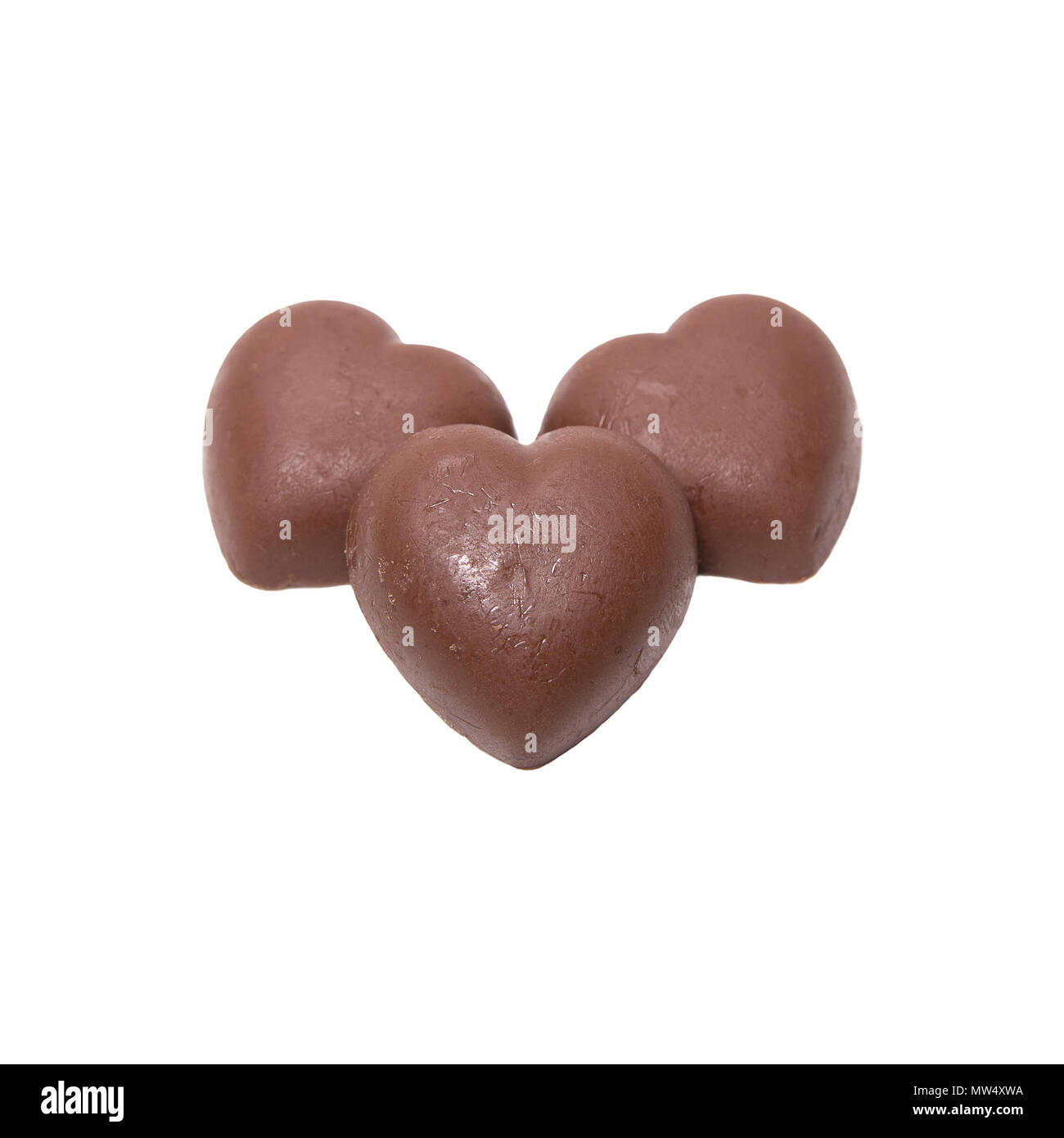 Three chocolate heart candy on white background Stock Photo - Alamy