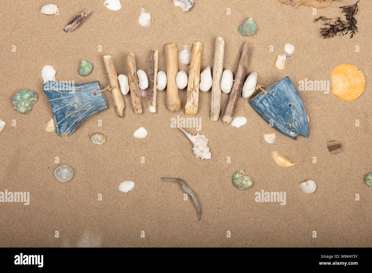 Decorative hand-crafted rustic fish of stones and wood joined with ...