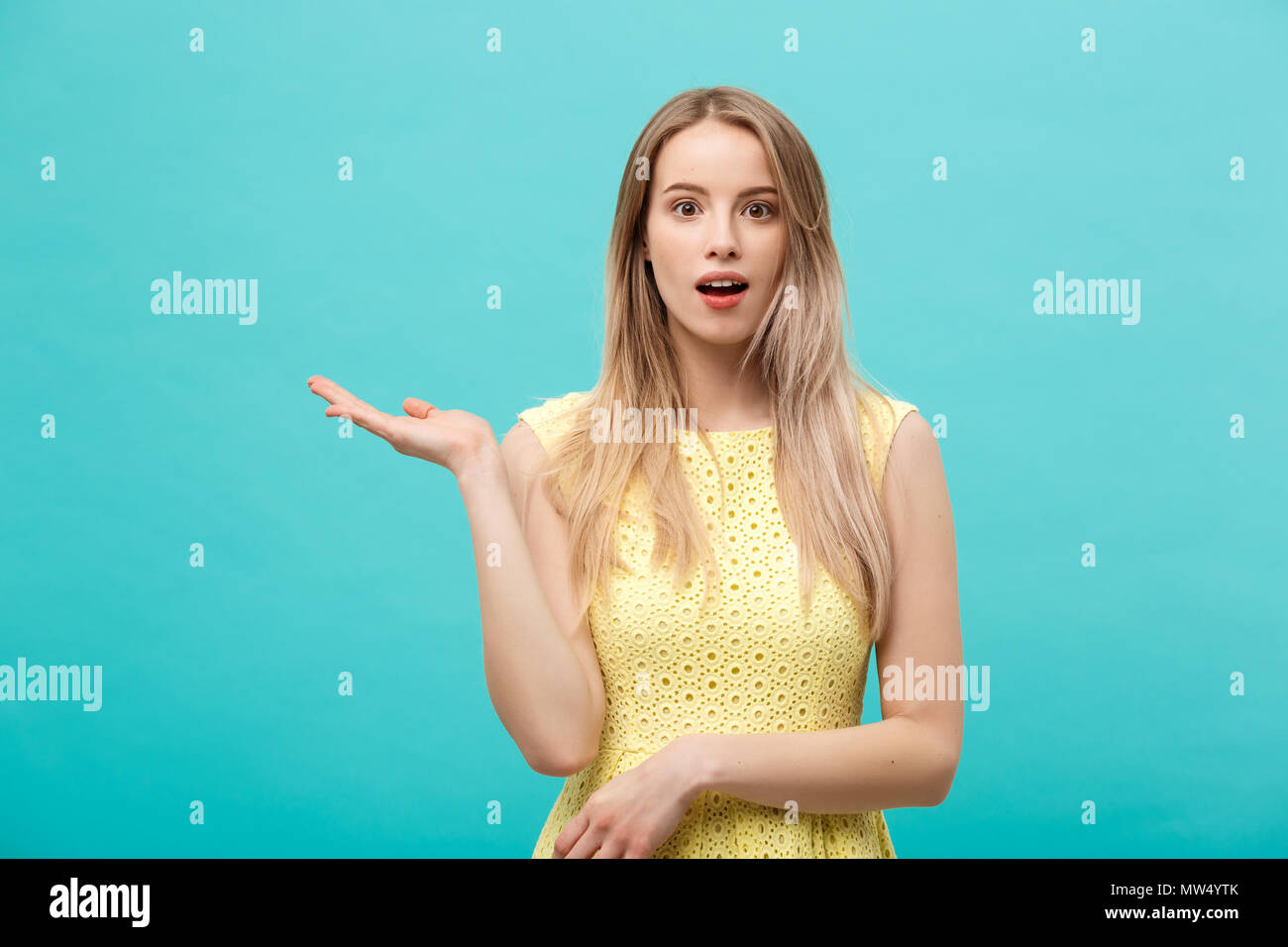 Woman surprise showing product. Beautiful girl with curly hairstyle ...