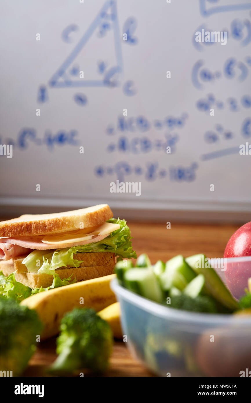 Preparing ham and cheese sandwiches for school lunchbox on wooden ...