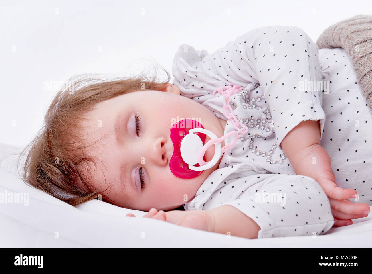 Cute baby girl inwhite body, crawling, laughing and playing at studio ...