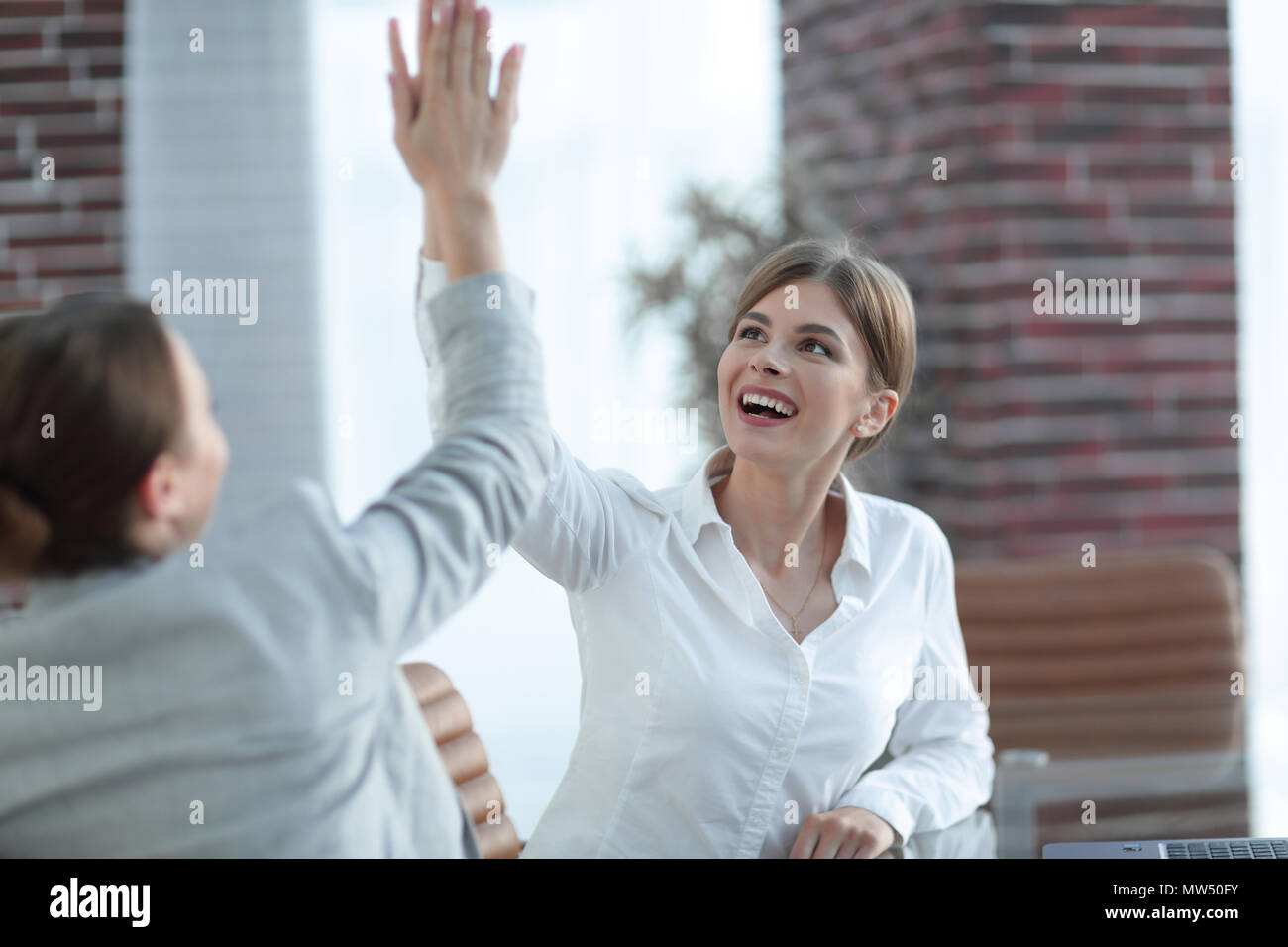 members of the business team giving each other a high five Stock Photo ...