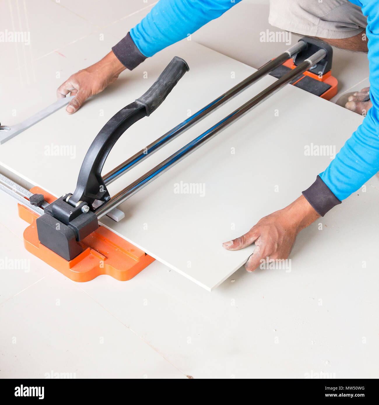 Industrial tiler builder worker working with floor tile cutting ...