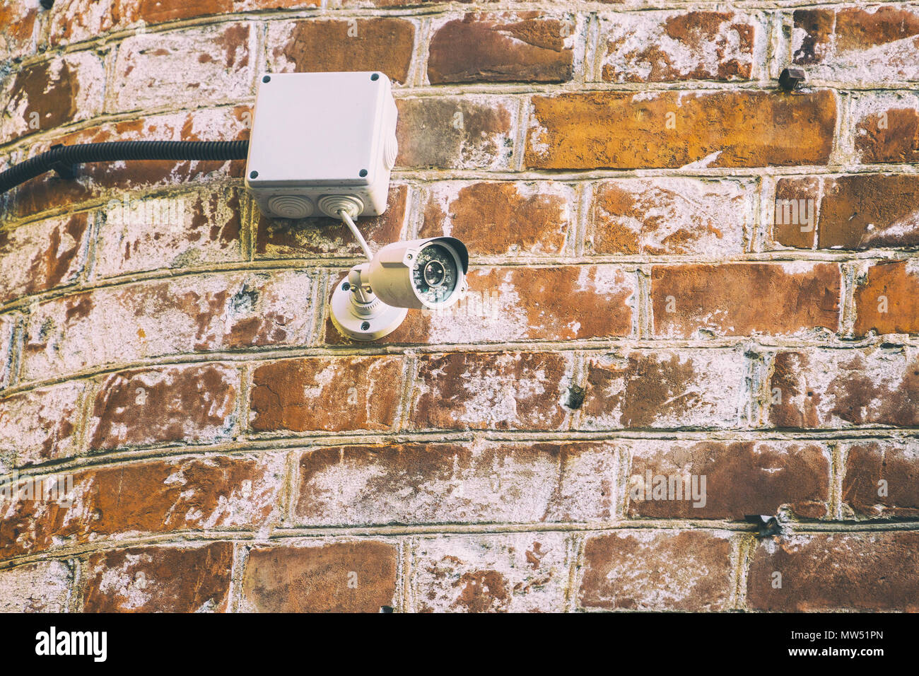 CCTV camera on the wall of red brick Stock Photo - Alamy