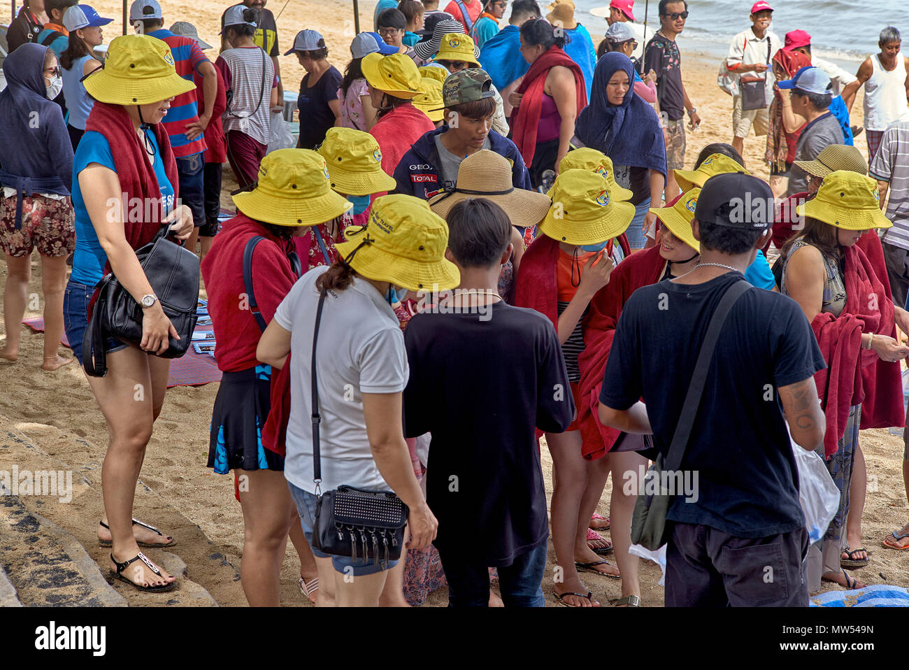 Chinese tourists. Pattaya Beach Thailand. Yellow hats worn to identify ...