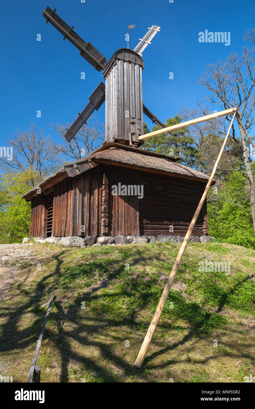 Old wooden windmill under blue sky, vertical rural Swedish landscape ...