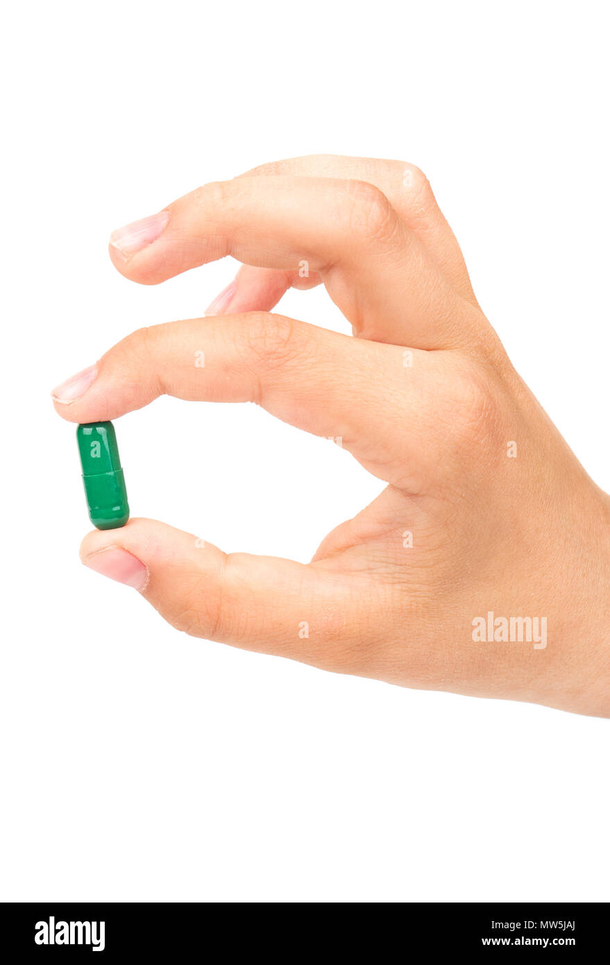 Green herbal capsule in hand on white background Stock Photo - Alamy