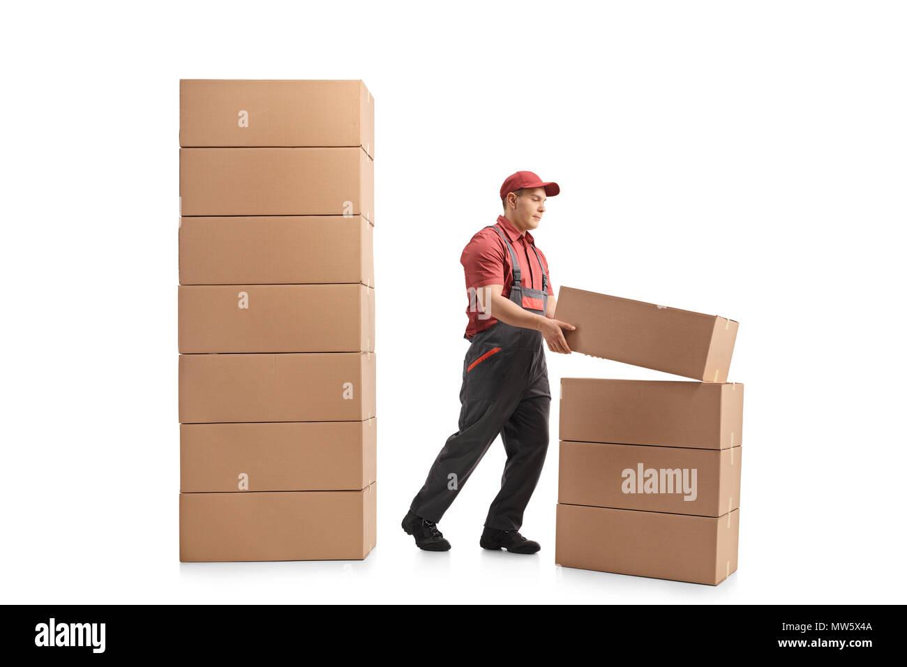 Full length profile shot of a mover placing a package on top of a stack ...