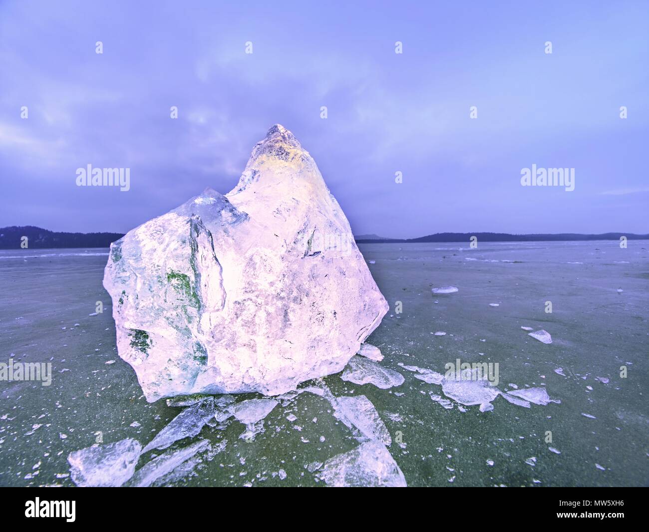 Ice floe and crushed ice on dark frozen and flat ground. Shining ...