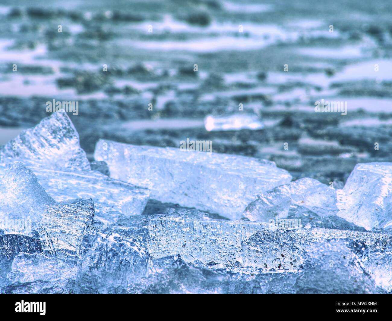 Winter coastal under icy cover. Icy andscape with broken pieces of blue ...