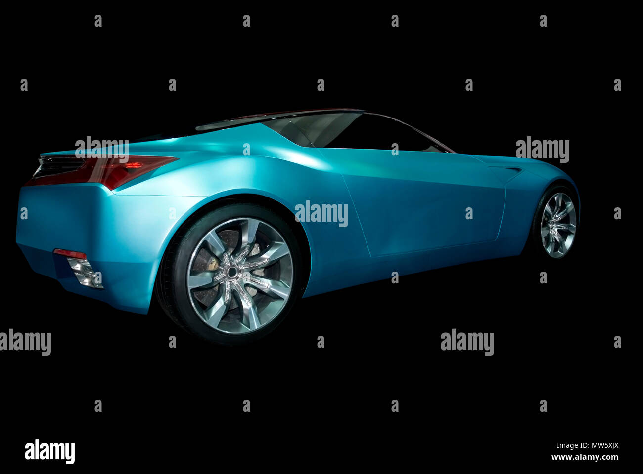 Blue sports car isolated on a black background. Clipping paths included ...