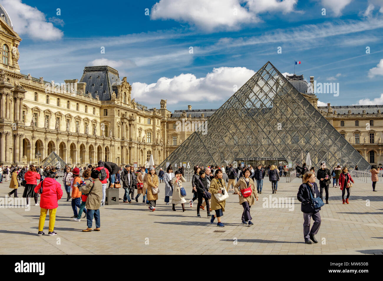 People outside The Louvre Pyramid , the main entrance to the The Louvre ...