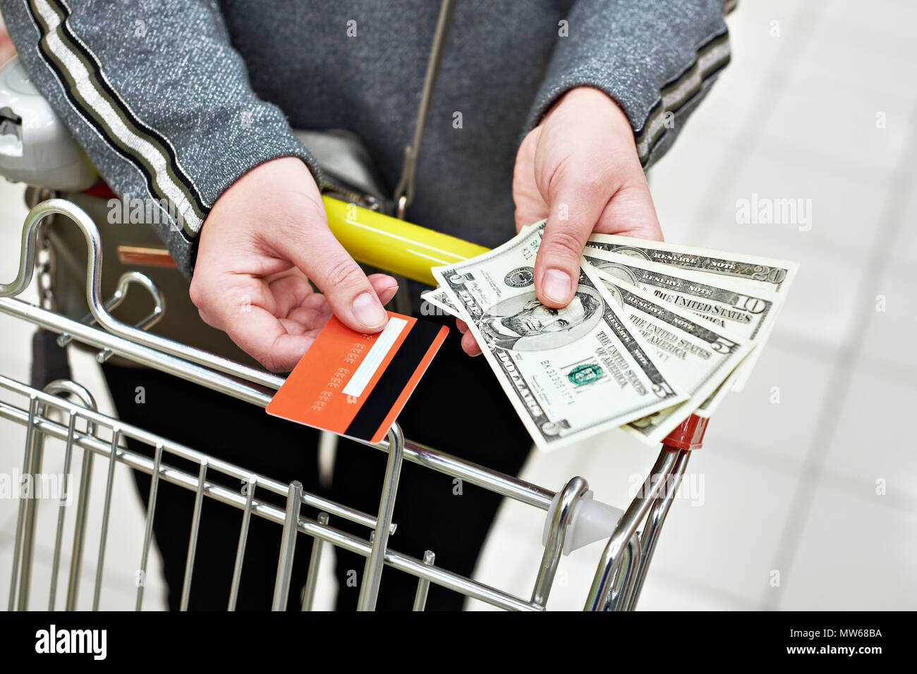 Bank card and dollar bills in the buyers hand in the store Stock Photo ...