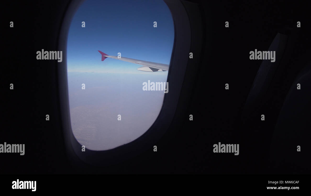 Mountain range from the airplane window. Airplane wing. Aerial view on ...