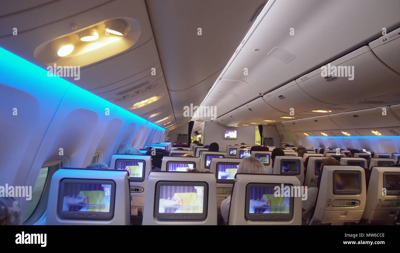 Interior passengers airplane with people on seats. Aircraft cabin with ...