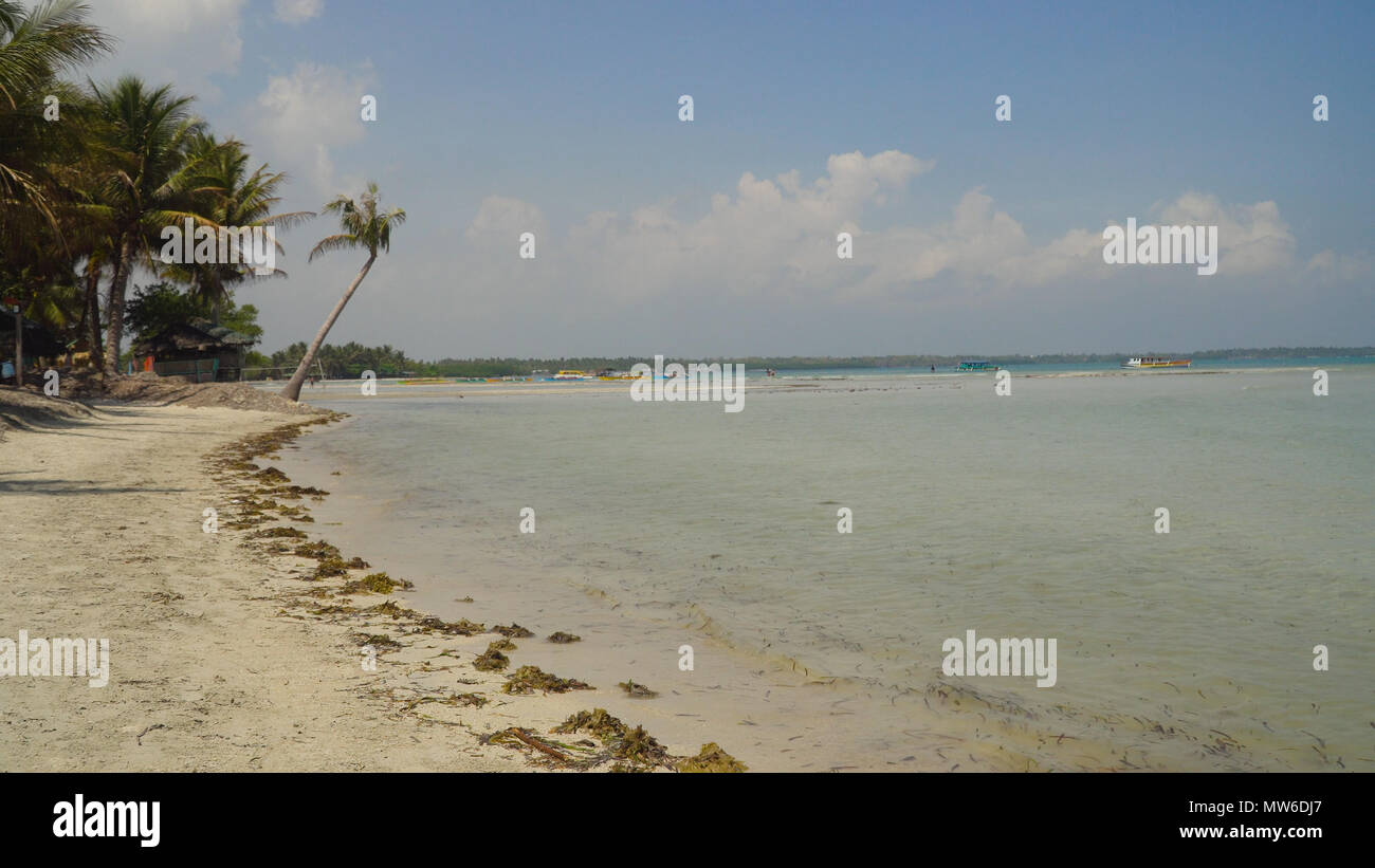 Tropical island with white sandy beach in blue lagoon. Tondol white ...