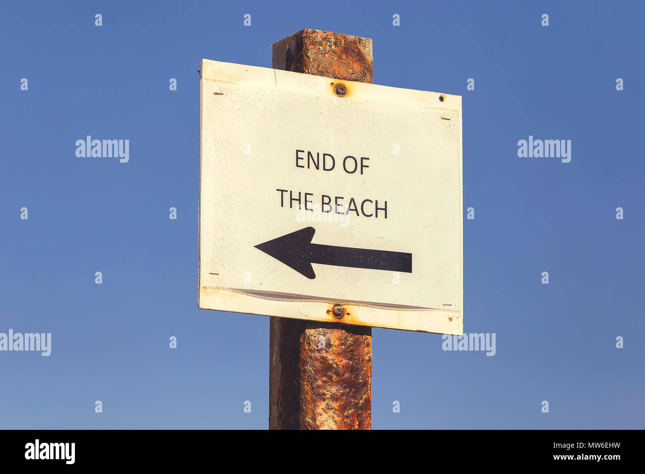 End of the beach metal sign with blue sky background. Vintage style ...