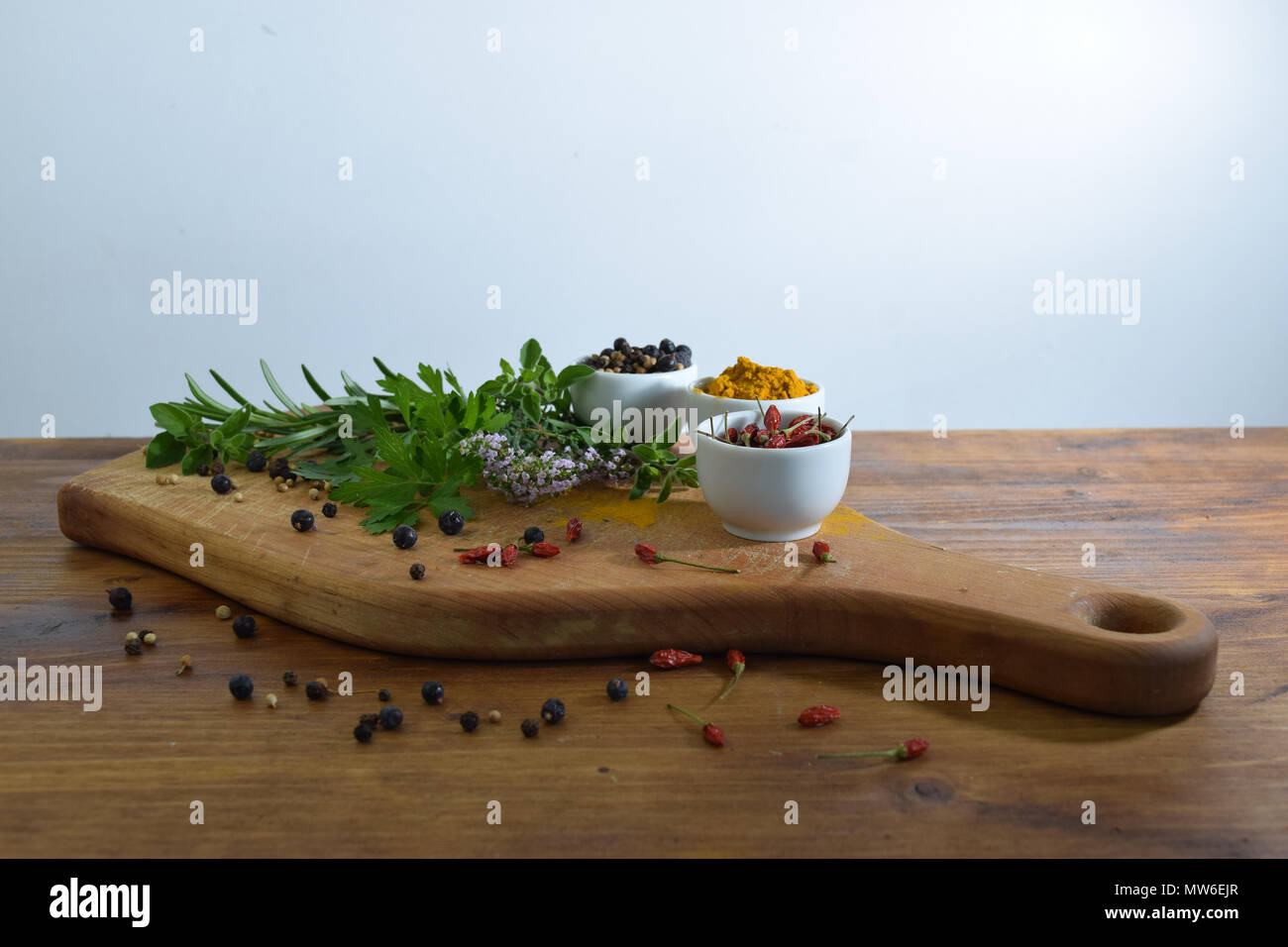 spices and aromatic herbs on a wooden chopping board Stock Photo - Alamy