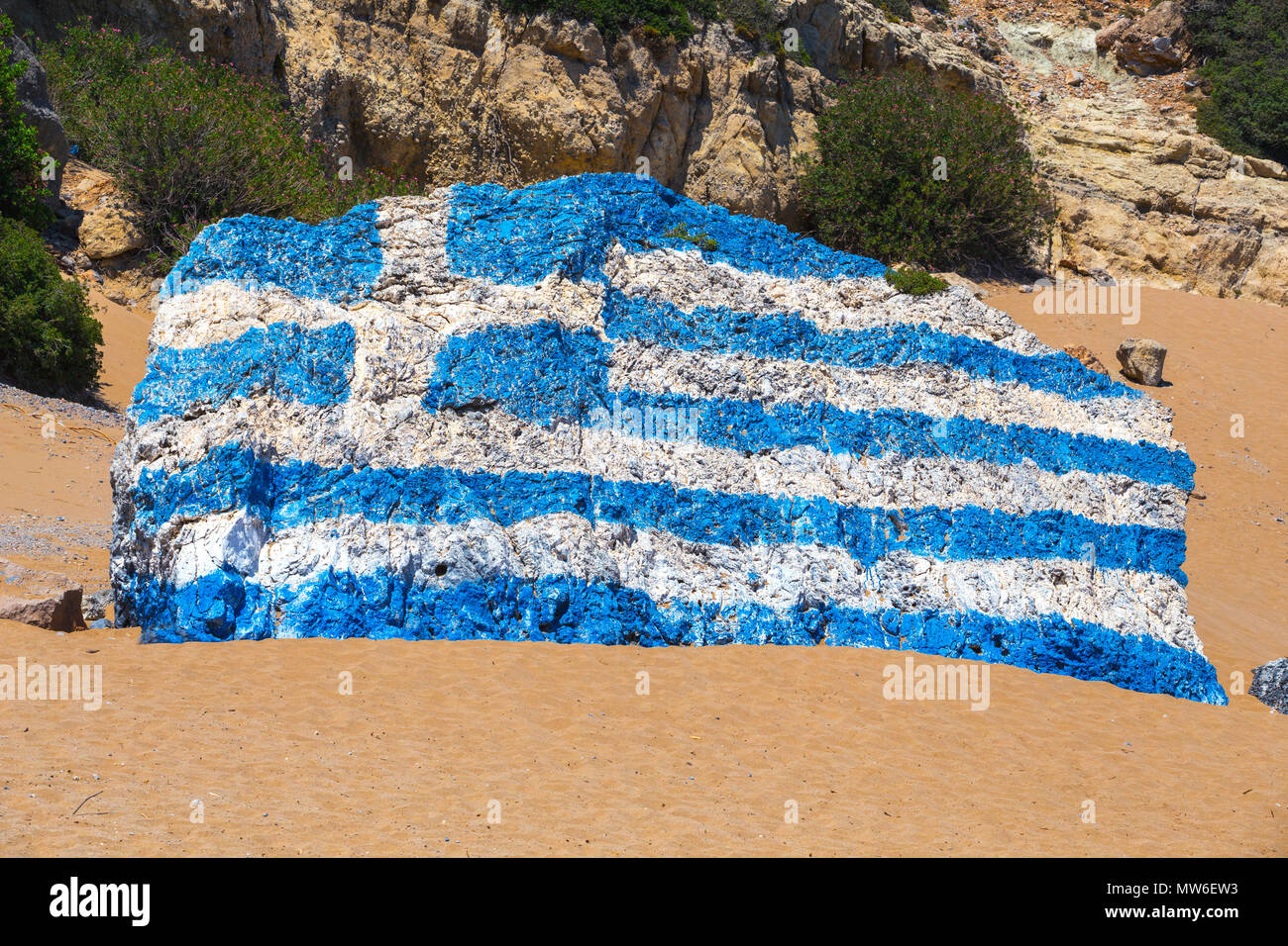 Greece flag painted on rock at Tsambika beach, Rhodes, Greece Stock ...