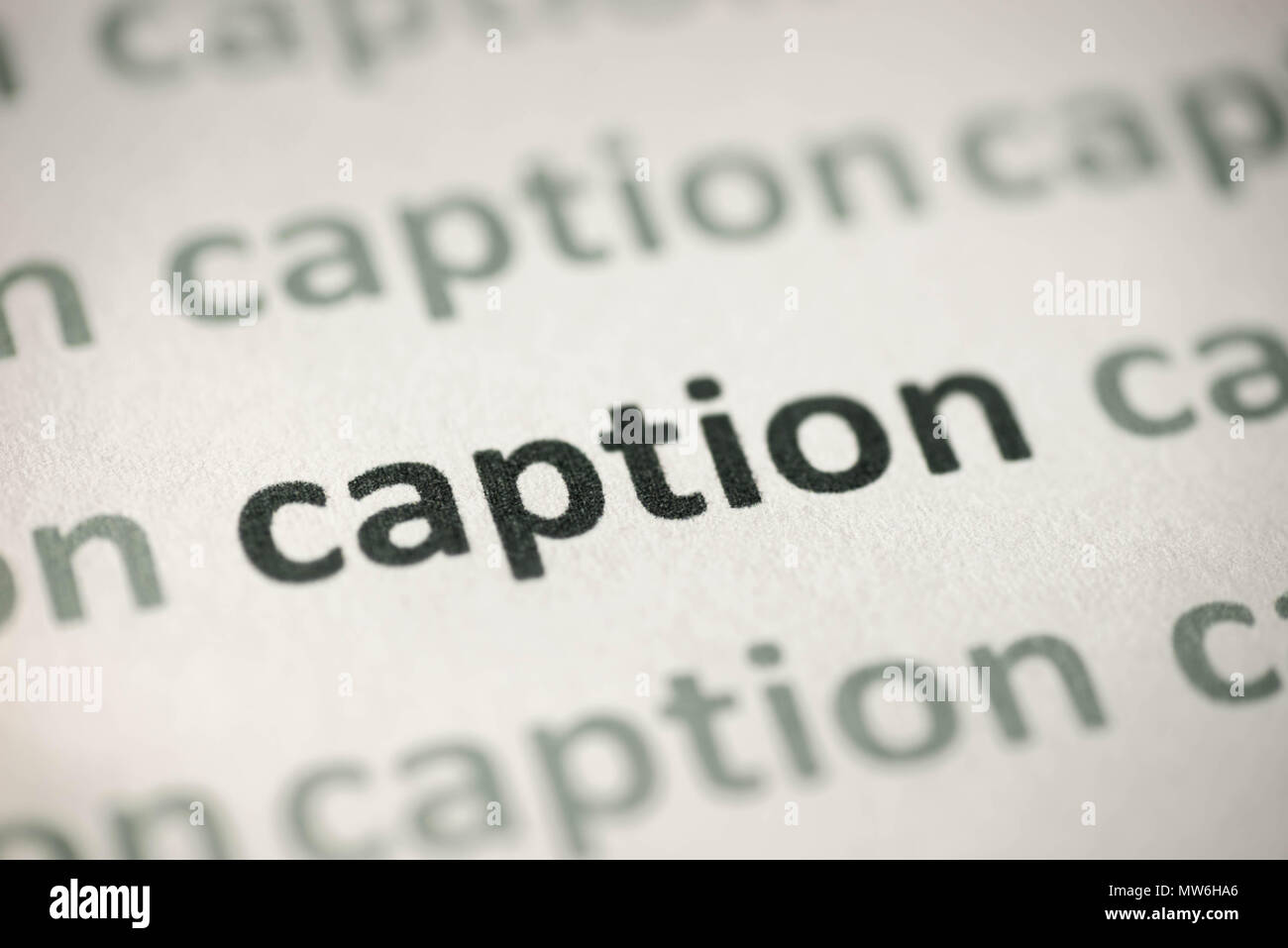 word caption printed on white paper macro Stock Photo - Alamy