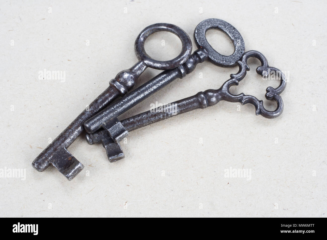 old vintage key on white textured background Stock Photo - Alamy