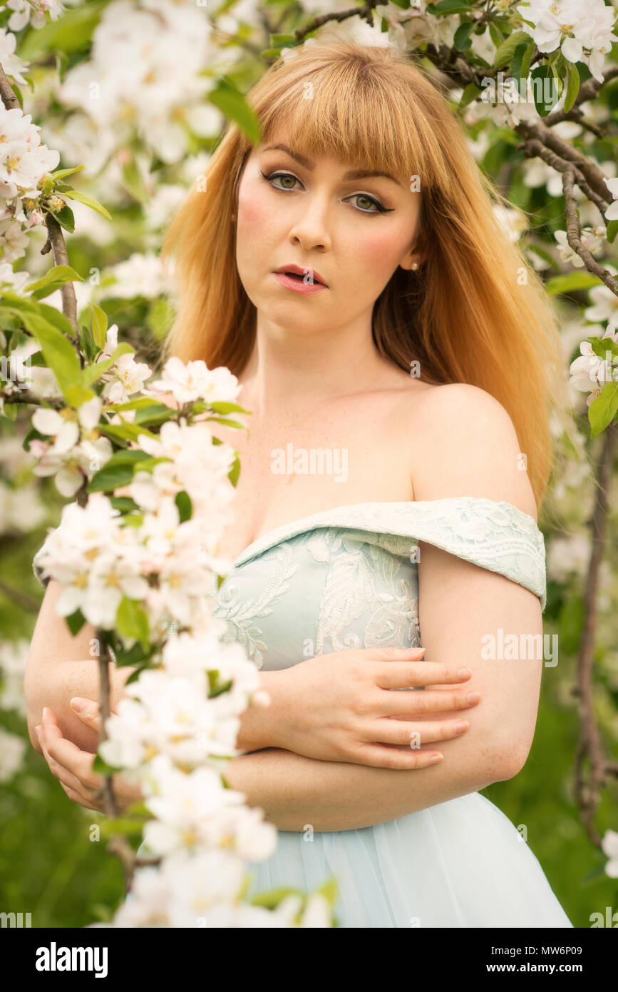 Woman with long blonde hair in Spring blossom Stock Photo - Alamy