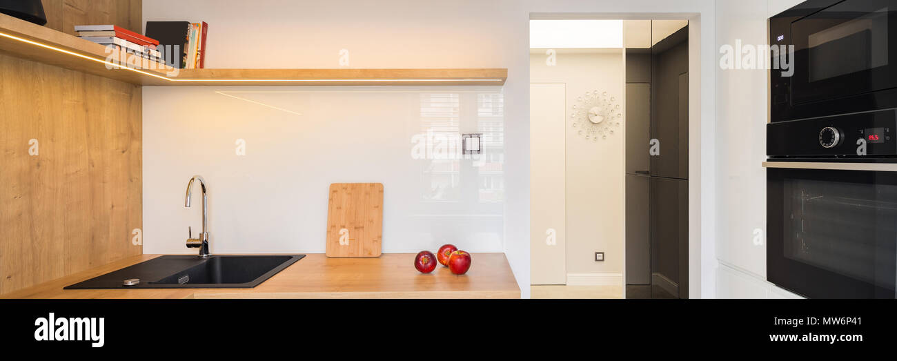 Panoramic view of contemporary kitchen interior with wooden worktop ...