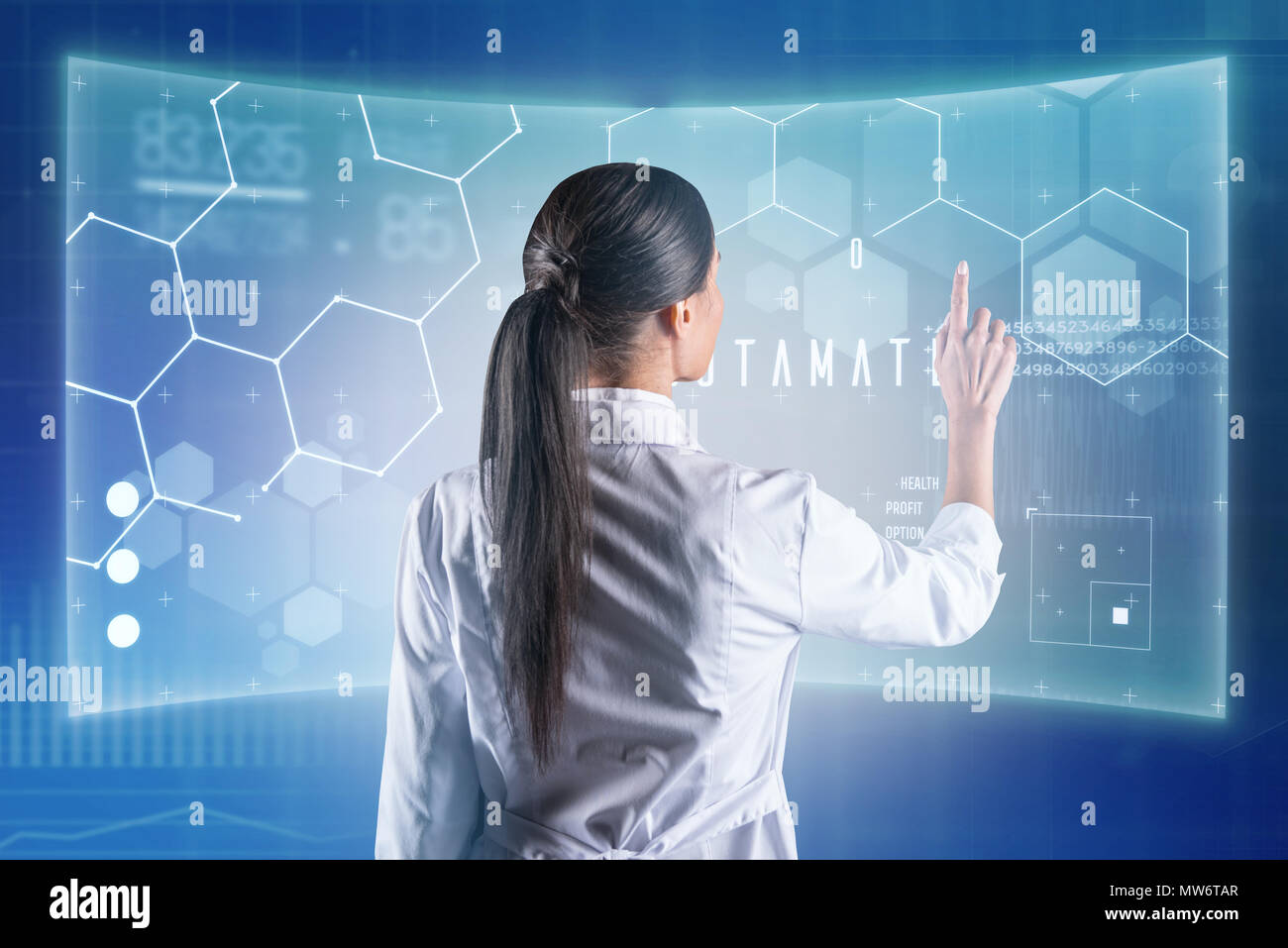Progressive biologist touching a transparent screen while working Stock ...