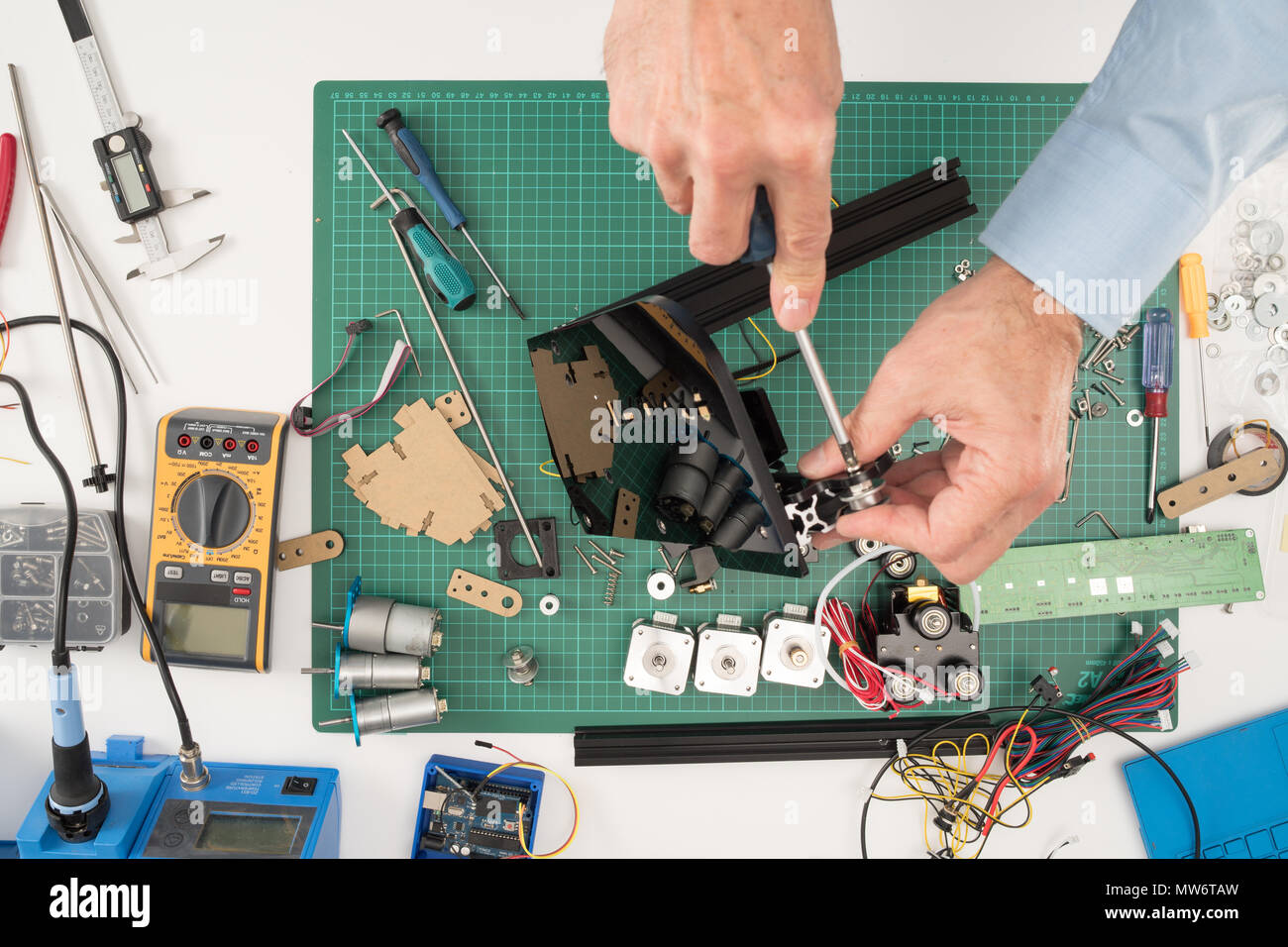 manual assembly of electronic mechanical device from a set of spare ...