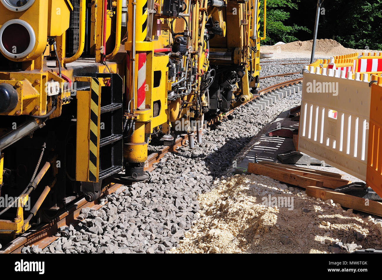 track laying machine at streetcar construction site with concrete ...