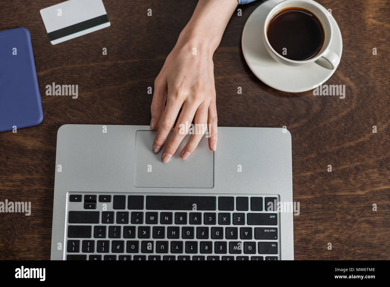 Overhead view of working desk with person using laptop computer Stock ...