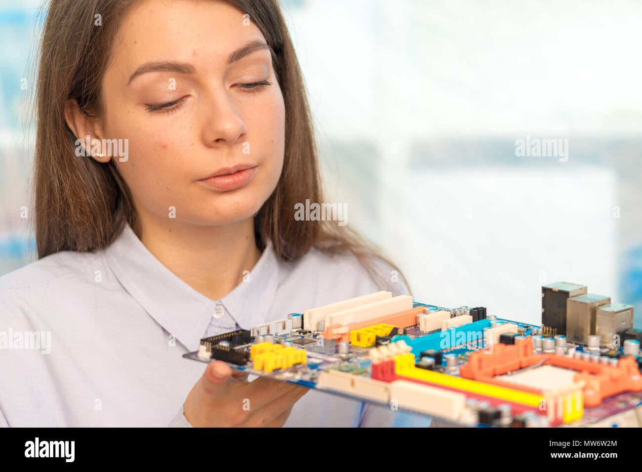Female student in electronics class uses a Measuring device Stock Photo ...