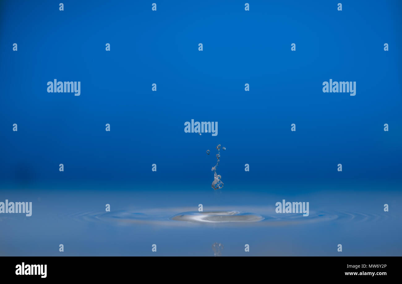 Water drop falling into water making a perfect droplet splash Stock ...