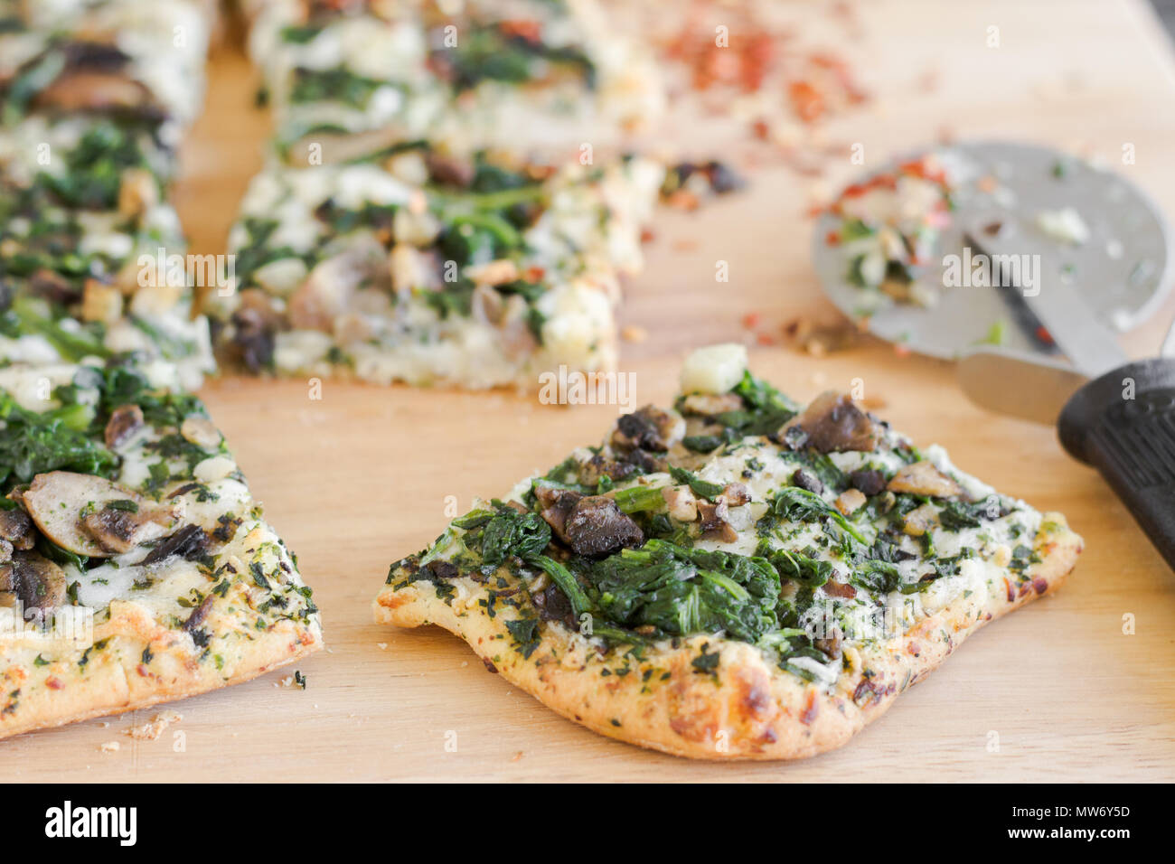 Steaming hot Detroit style pizza with cheese, spinach and mushroom ...