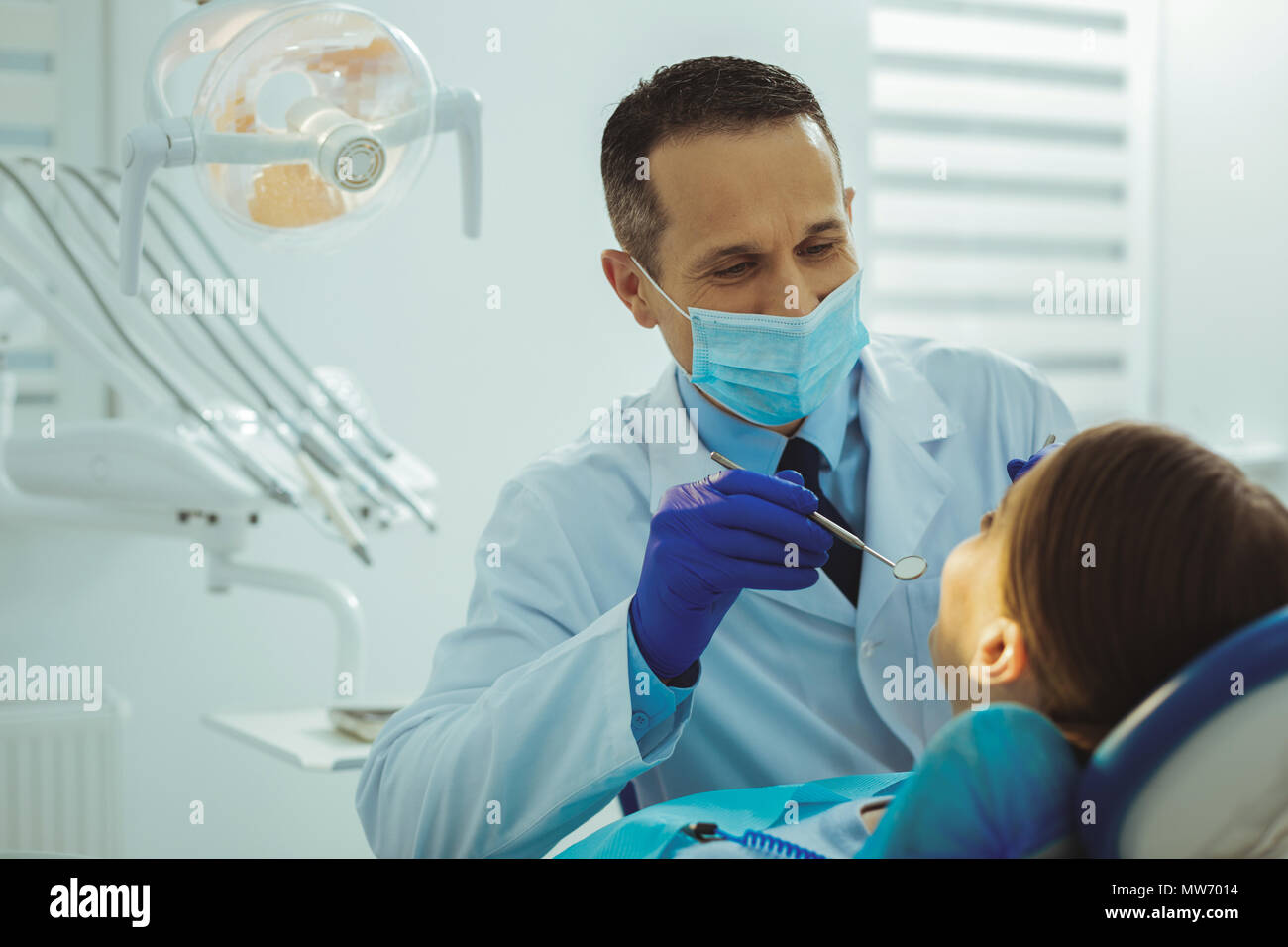 Competent stomatologist looking at his patient Stock Photo - Alamy