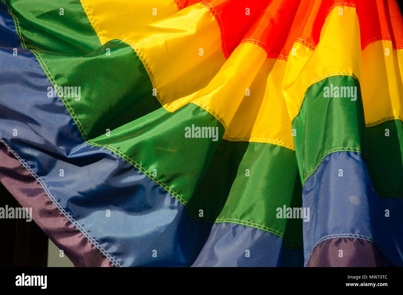 Rainbow color bunting decorates a building on 14th Street NW, during ...