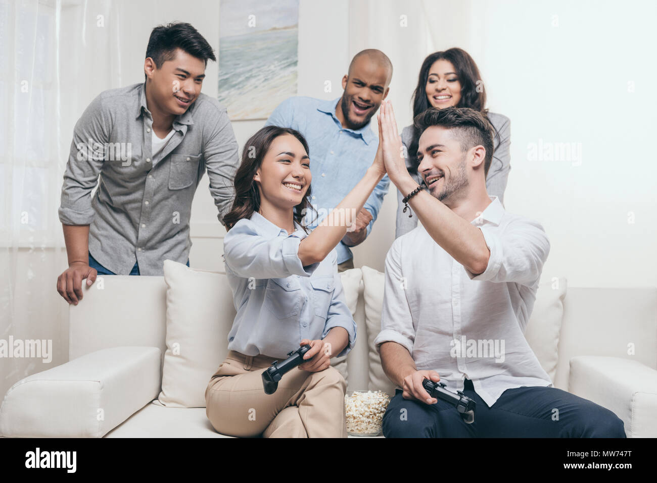 Playing video games high five hi-res stock photography and images - Alamy