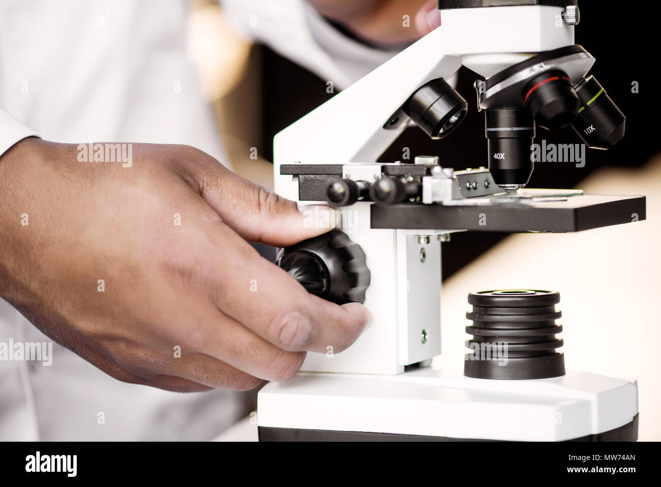 Cropped shot of a lab worker using a microscope Stock Photo - Alamy