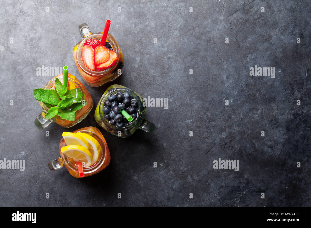 Fresh lemonade jar with summer fruits and berries. Top view with space ...