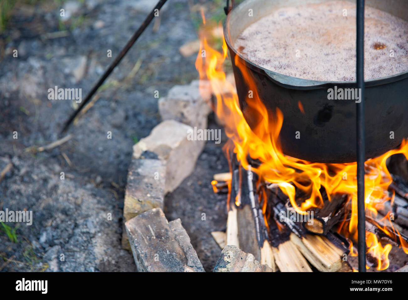 cooking in a cauldron at the stake. the food is cooked in a cauldron at ...