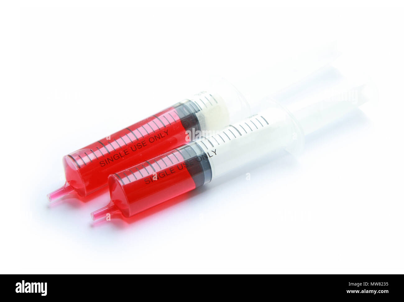 Syringe with red liquid isolated on white background Stock Photo - Alamy