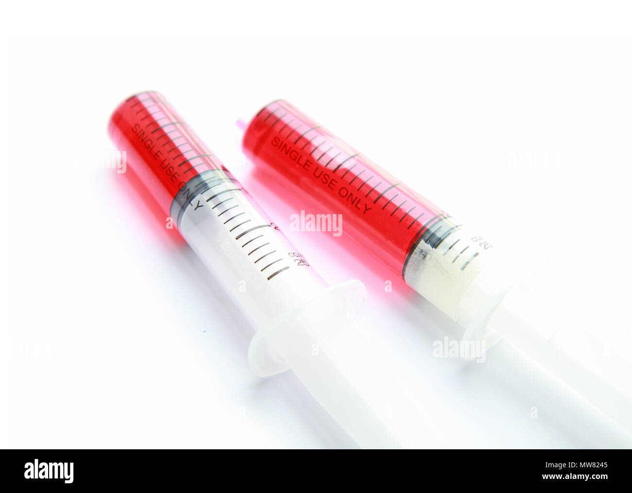Syringe with red liquid isolated on white background Stock Photo - Alamy
