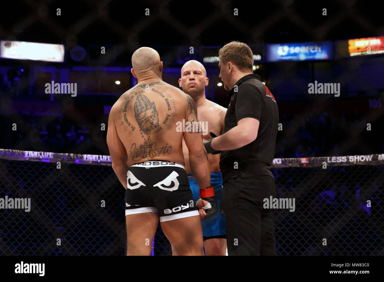 Referee Viktor Korneev explains the fight rules to two MMA fighters ...