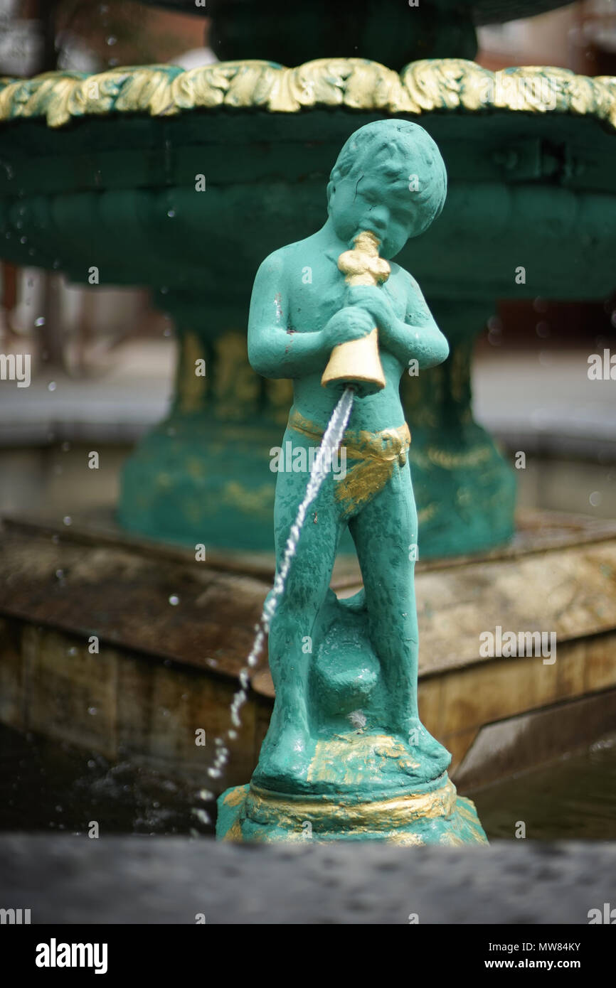 Green Cupid statue in a fountain Stock Photo - Alamy