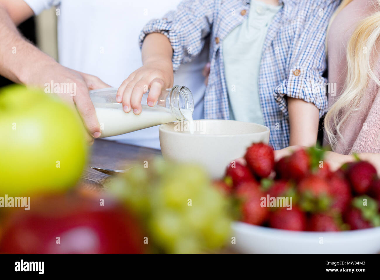 Child pouring milk hi-res stock photography and images - Alamy