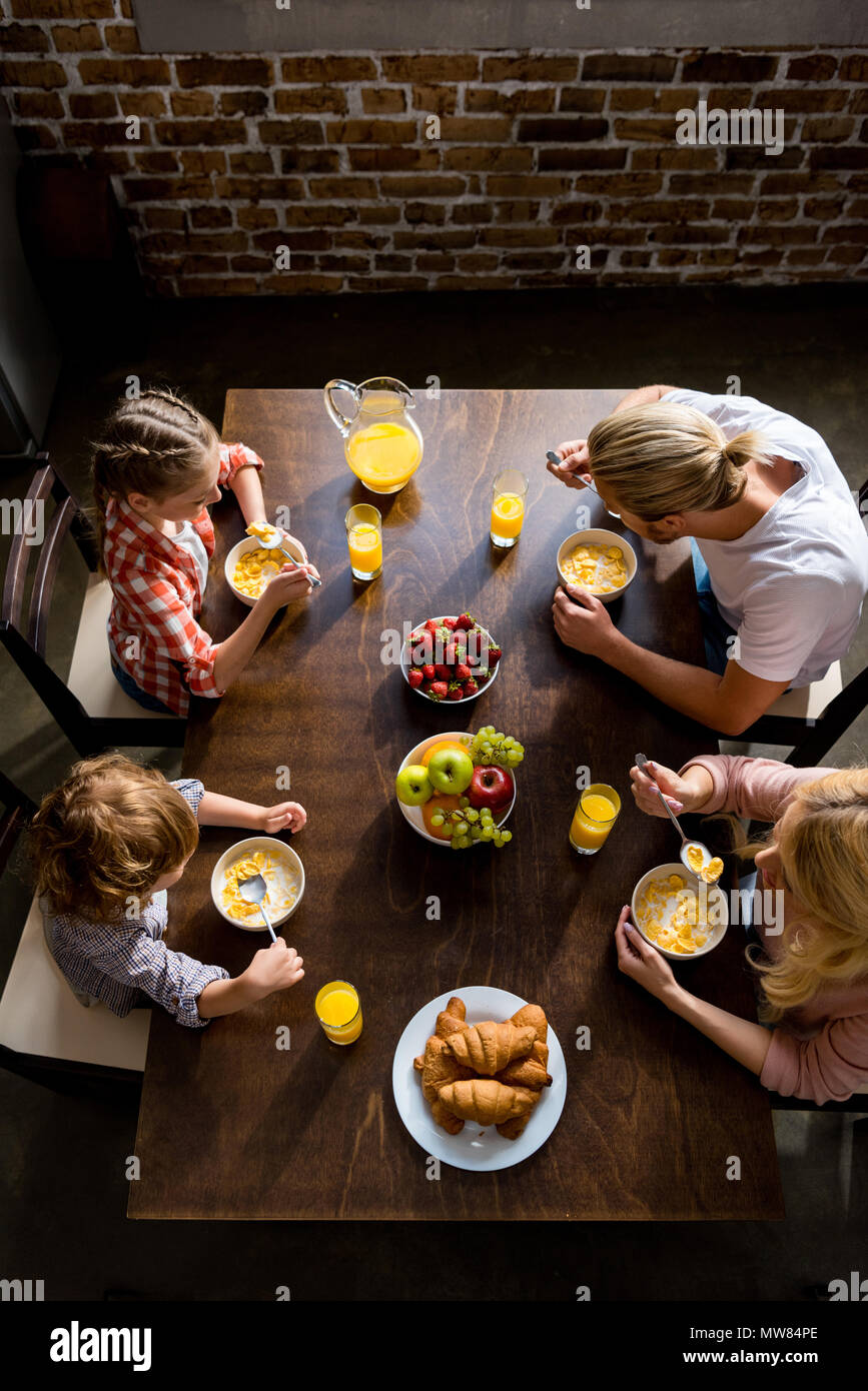 overhead view of family with two kids eating breakfast at home Stock ...