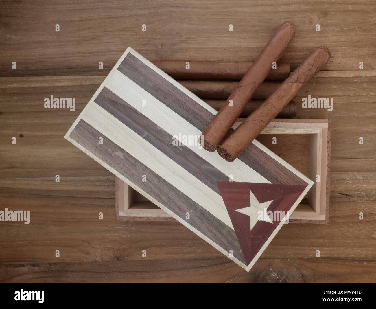 Studio scene of Cuban cigars and vintage cigar box on old wooden table ...