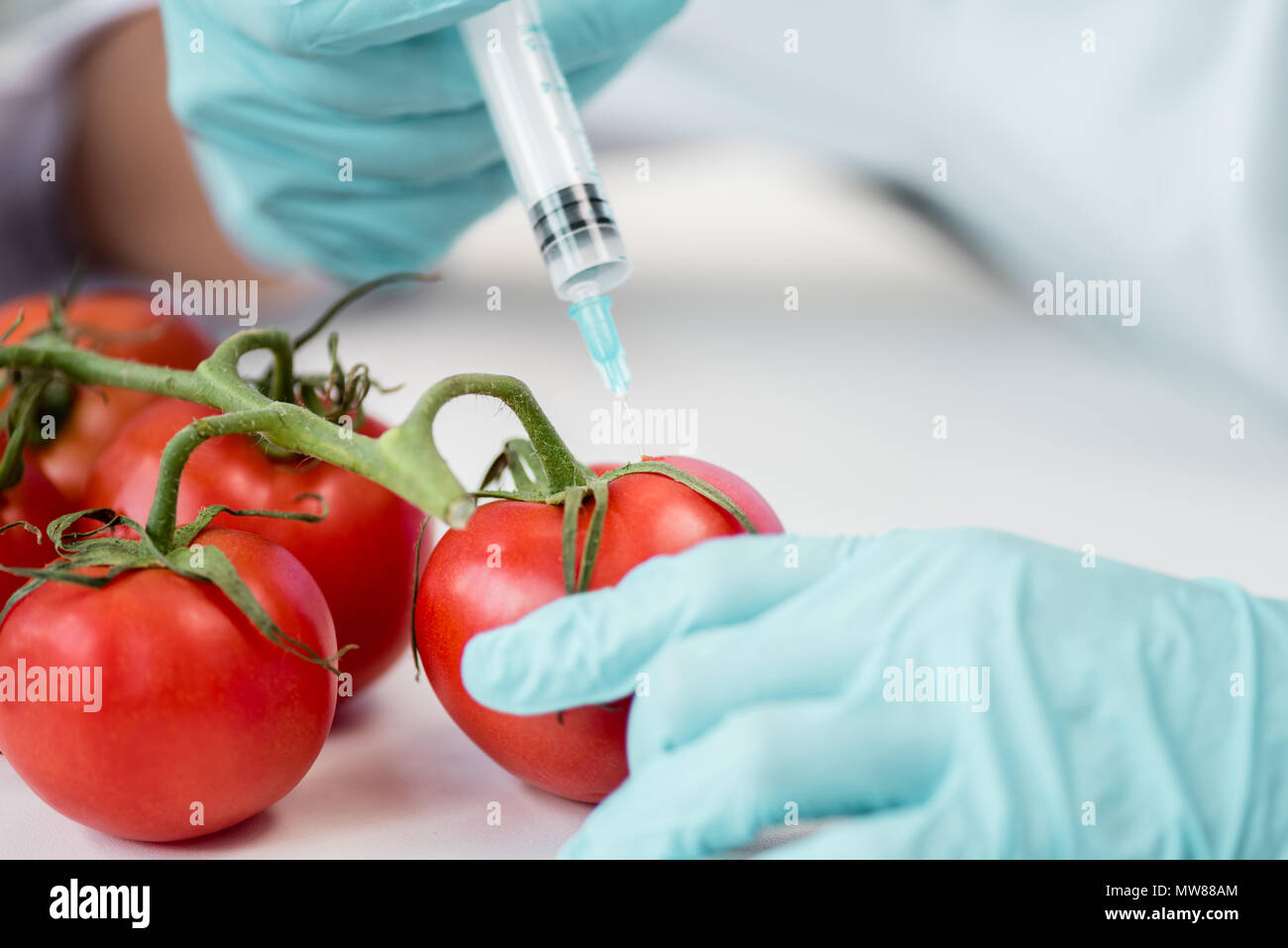 Cropped shot of scientist holding syringe and making experiment with ...