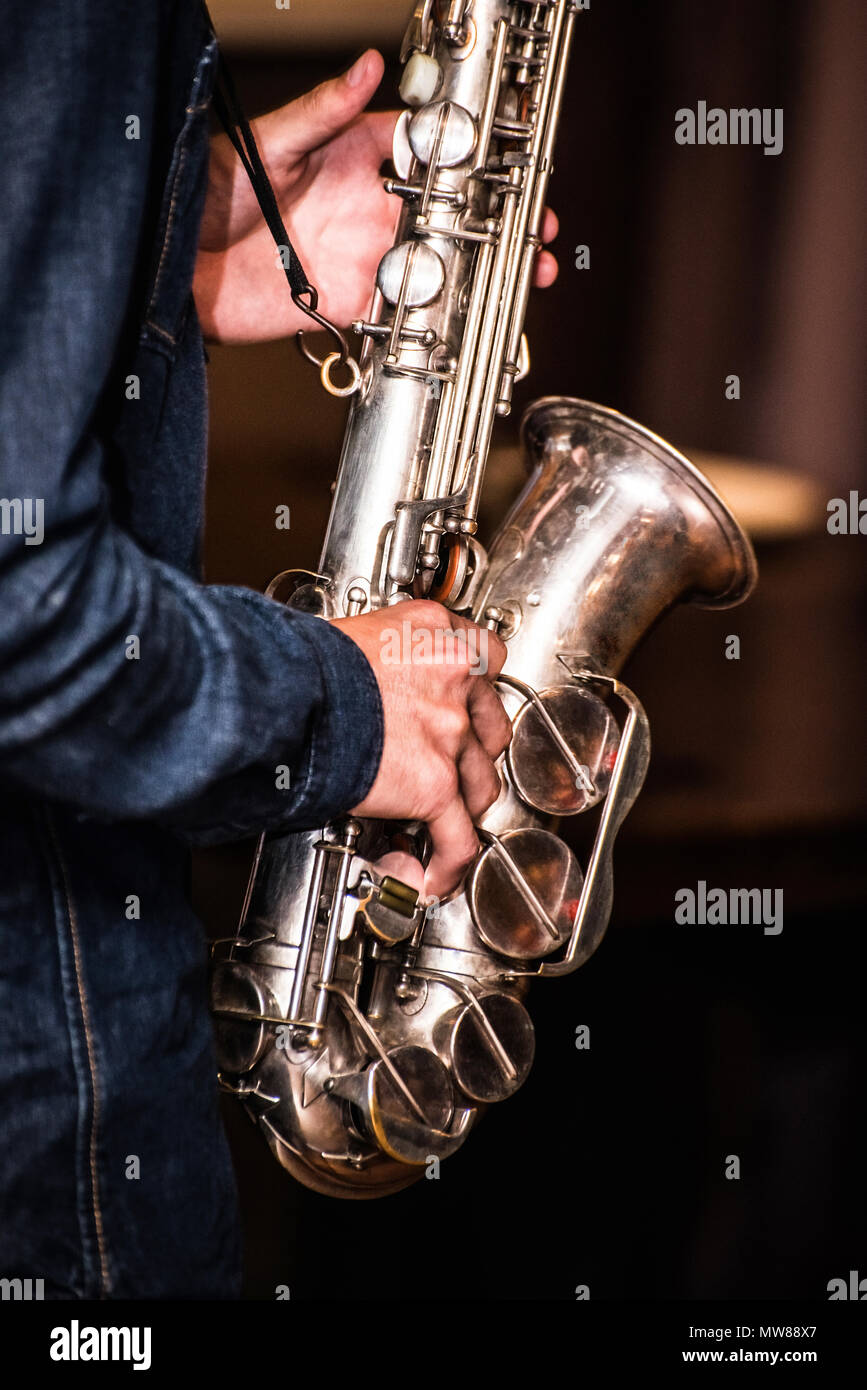 Saxophone in the hands of a musician Stock Photo - Alamy